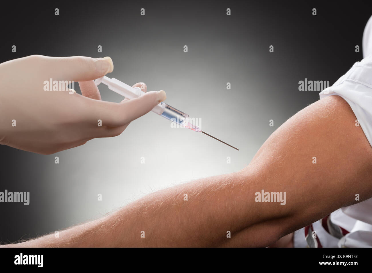 Close-up Of Doctor Injecting Injection On Patient's Arm Stock Photo - Alamy