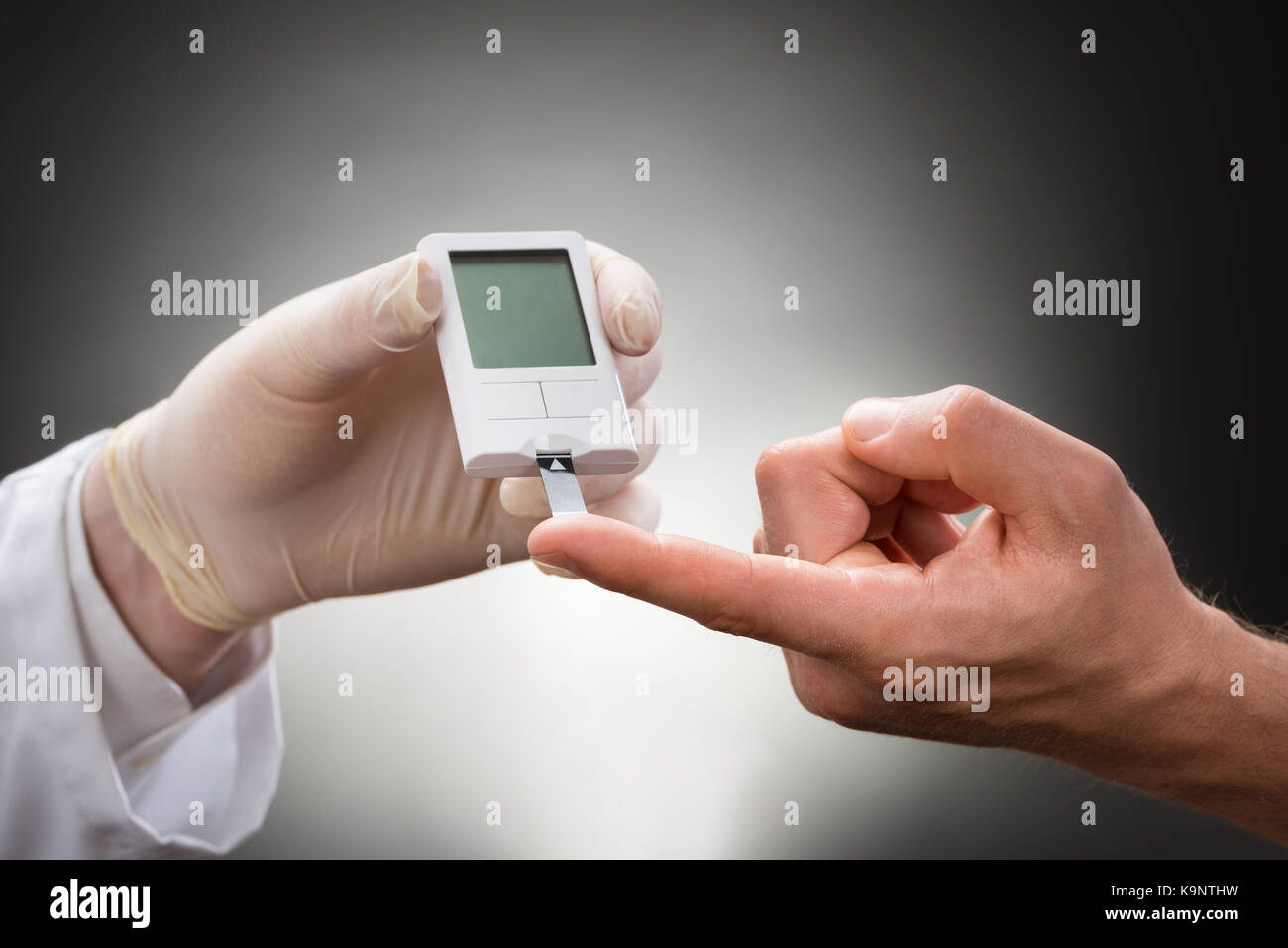 Doctor Measuring Sugar Reading Of Patient With Glucometer Stock Photo ...