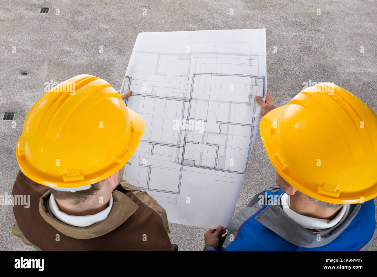 High Angle View Of Two Architects Discussing Blueprint Stock Photo - Alamy