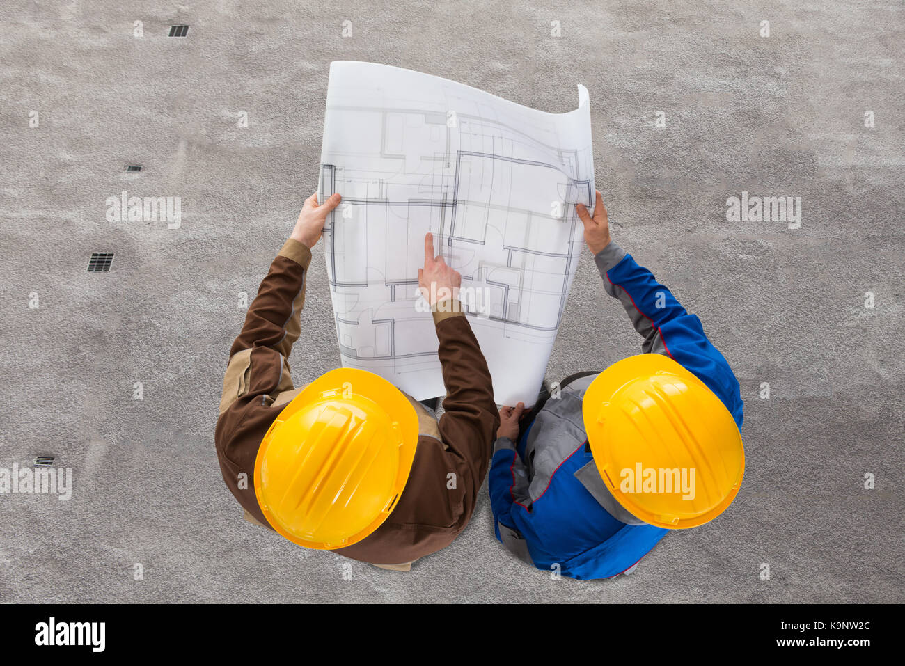 High Angle View Of Two Architects Discussing Blueprint Stock Photo - Alamy