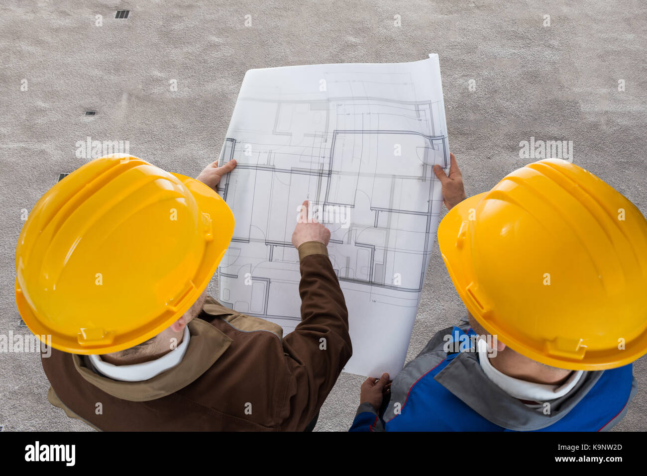 High Angle View Of Two Architects Discussing Blueprint Stock Photo - Alamy