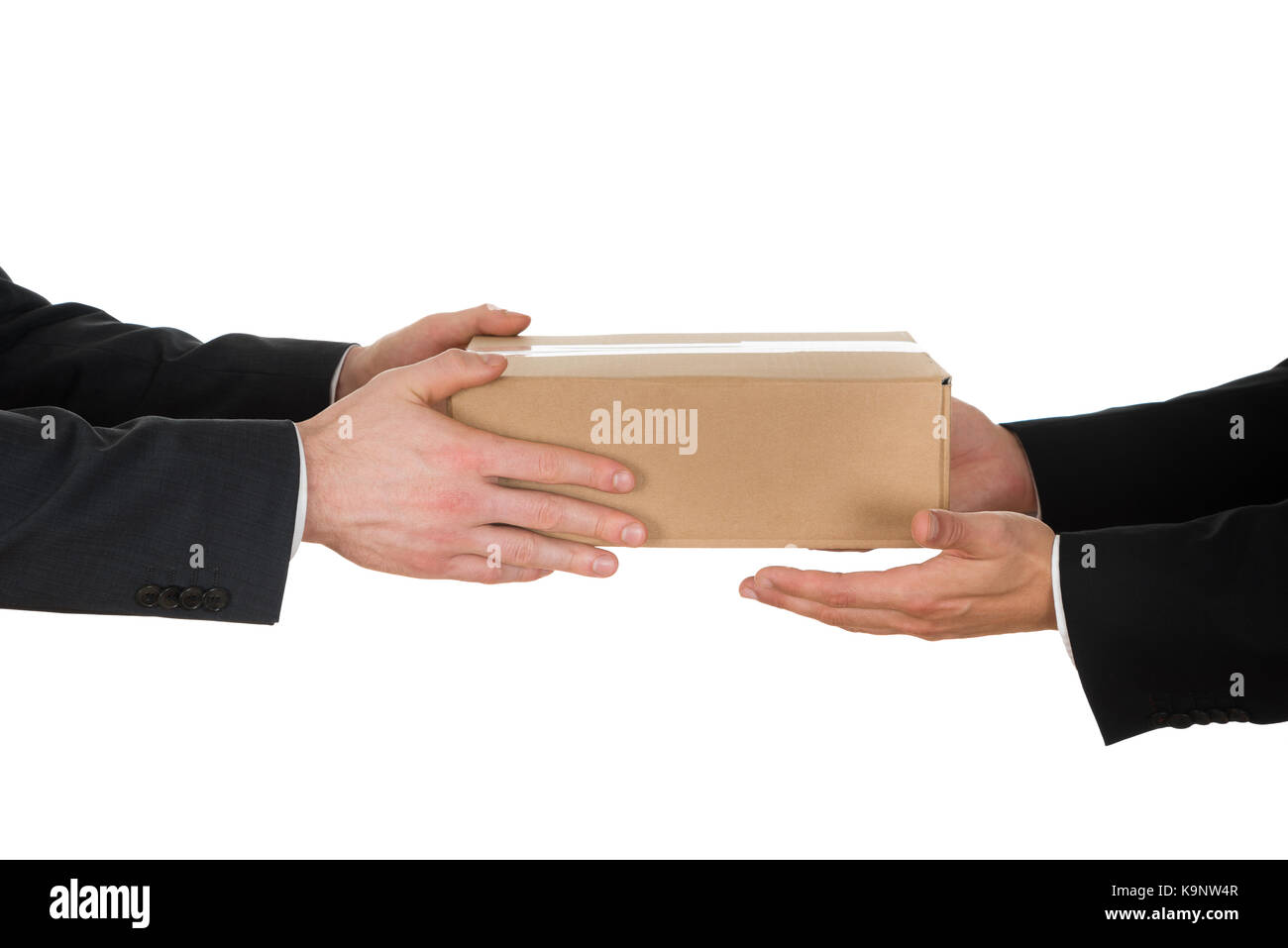 Close-up Of A Businessman Giving Box To His Colleague Over White ...
