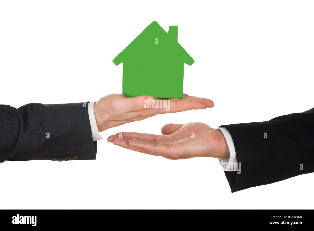 Close-up Of Businessman's Hand Holding Green House Model Over White ...