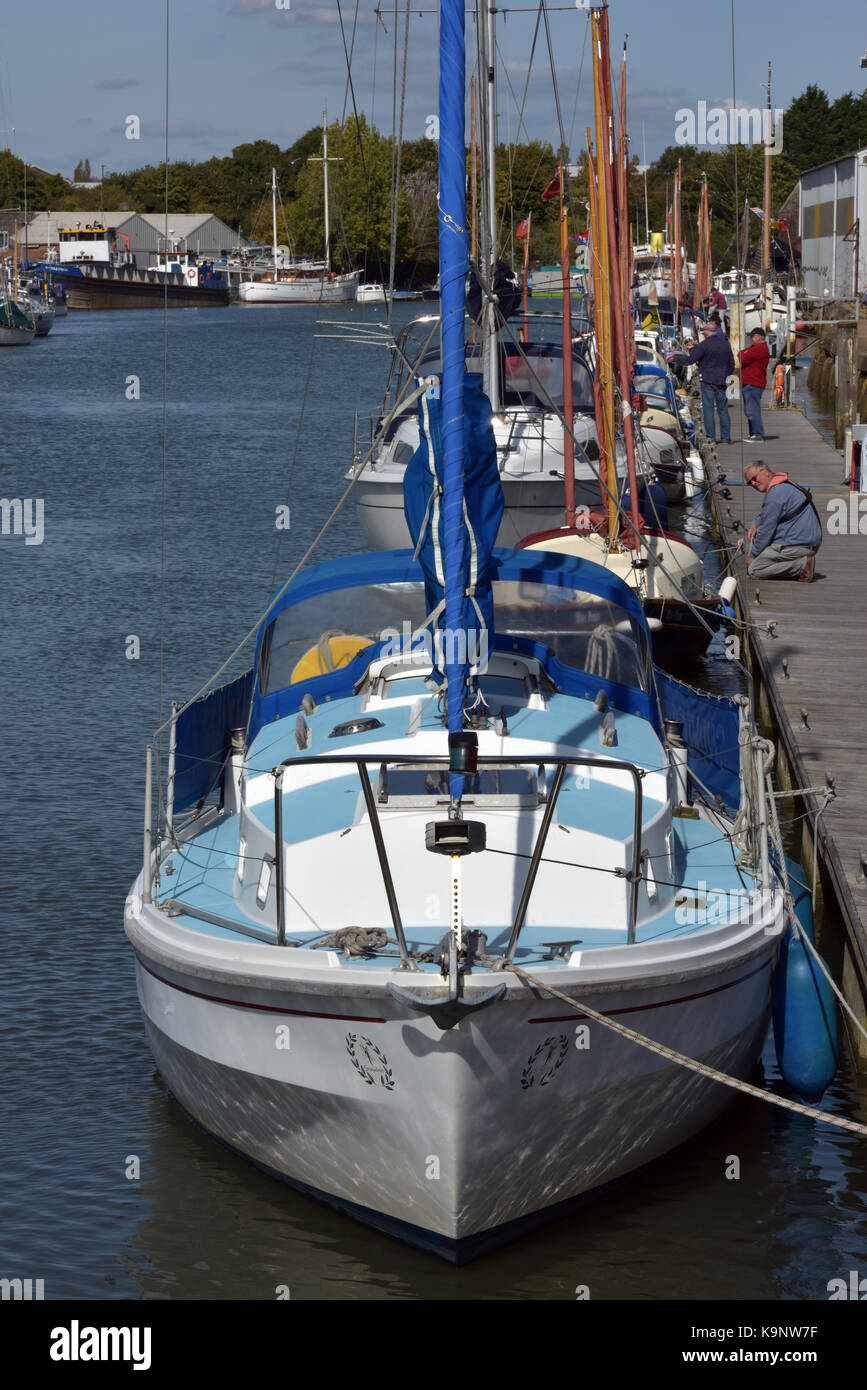 yachts mooring alongside a jetty in Newport harbour on the isle of ...
