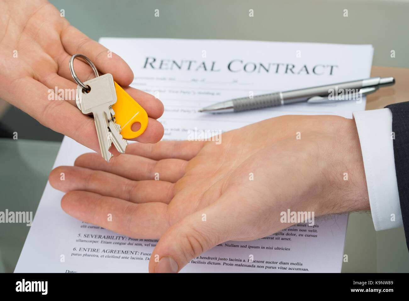 Close-up Of A Person Giving Key To Man Stock Photo - Alamy