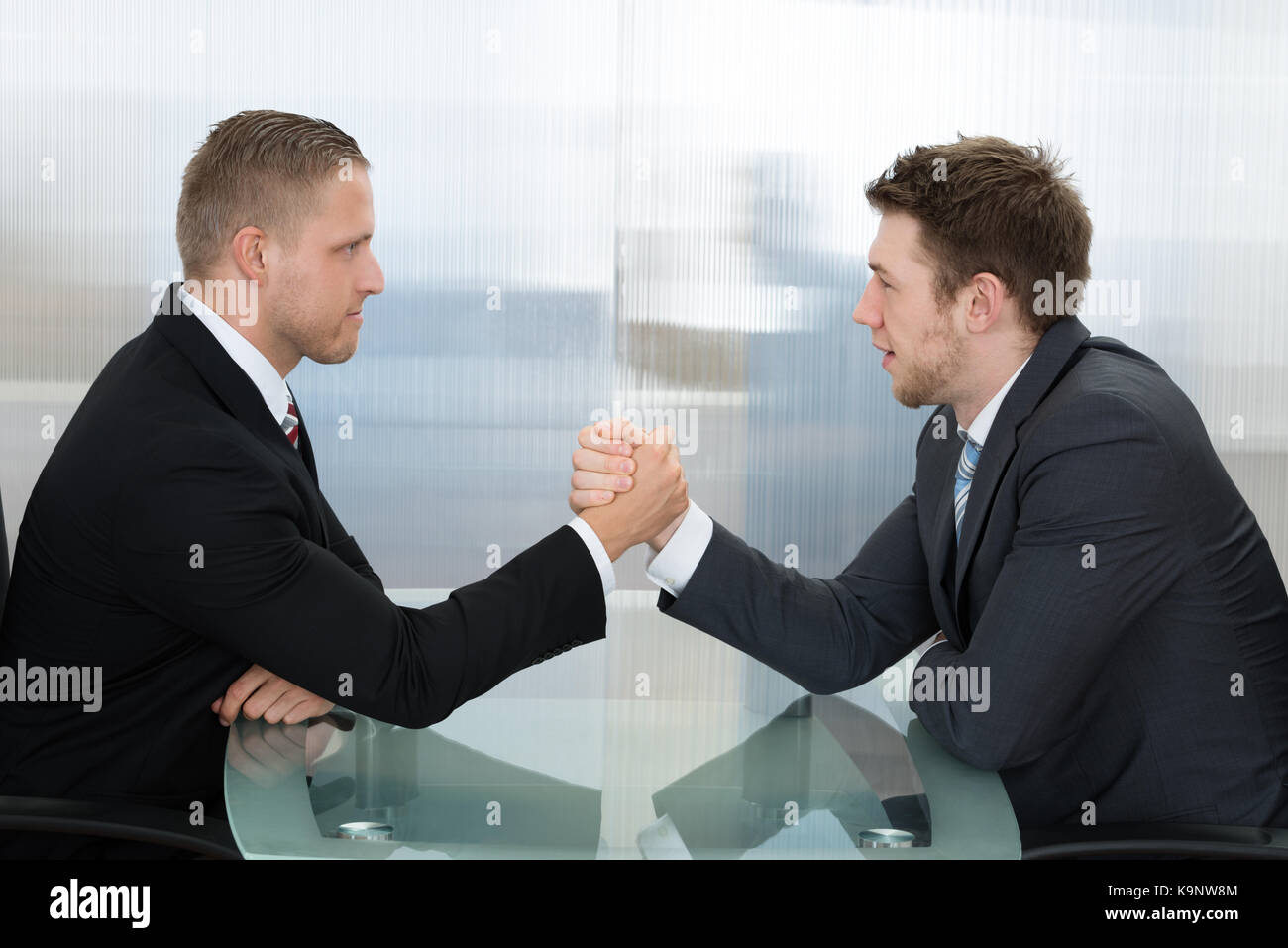 Two Young Businessman Holding Each Other Hands In The Office Stock ...