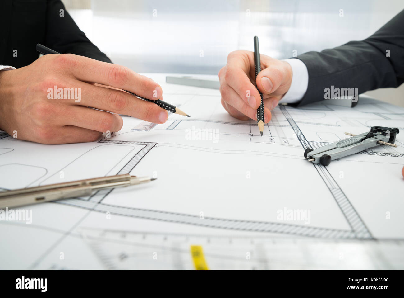 Close-up Of Two Architects Planning Project On Blueprint Stock Photo ...