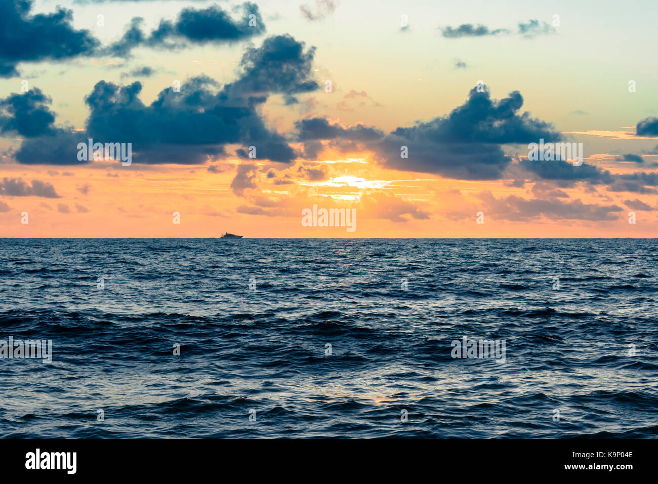 distant boat on the horizon on an early summer morning Stock Photo - Alamy
