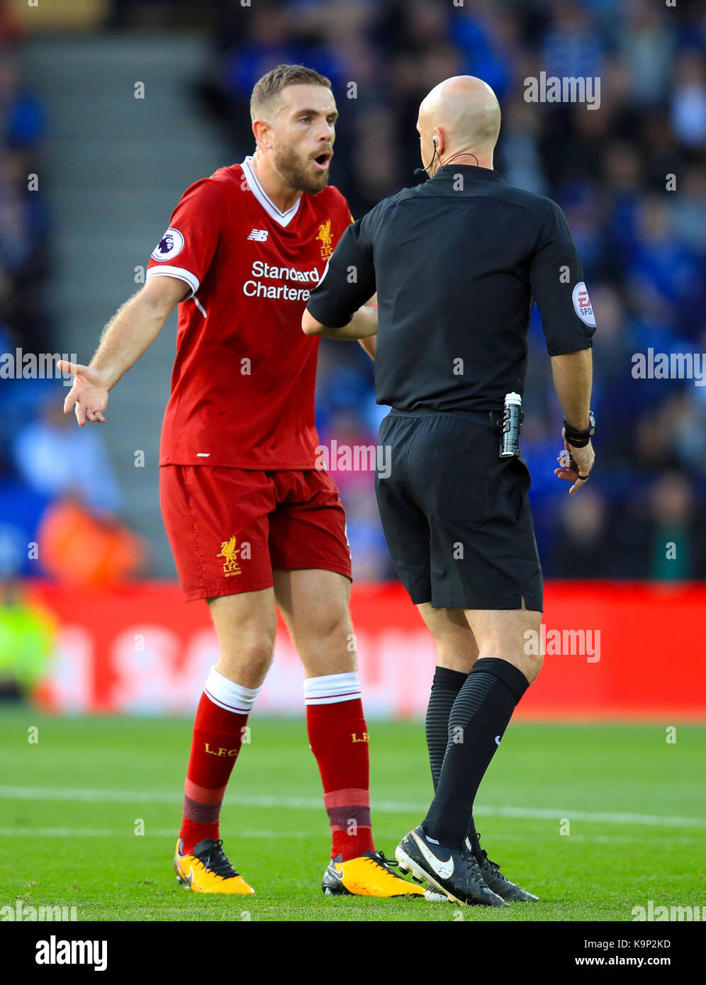 Liverpool's Jordan Henderson questions a decision with referee Anthony ...