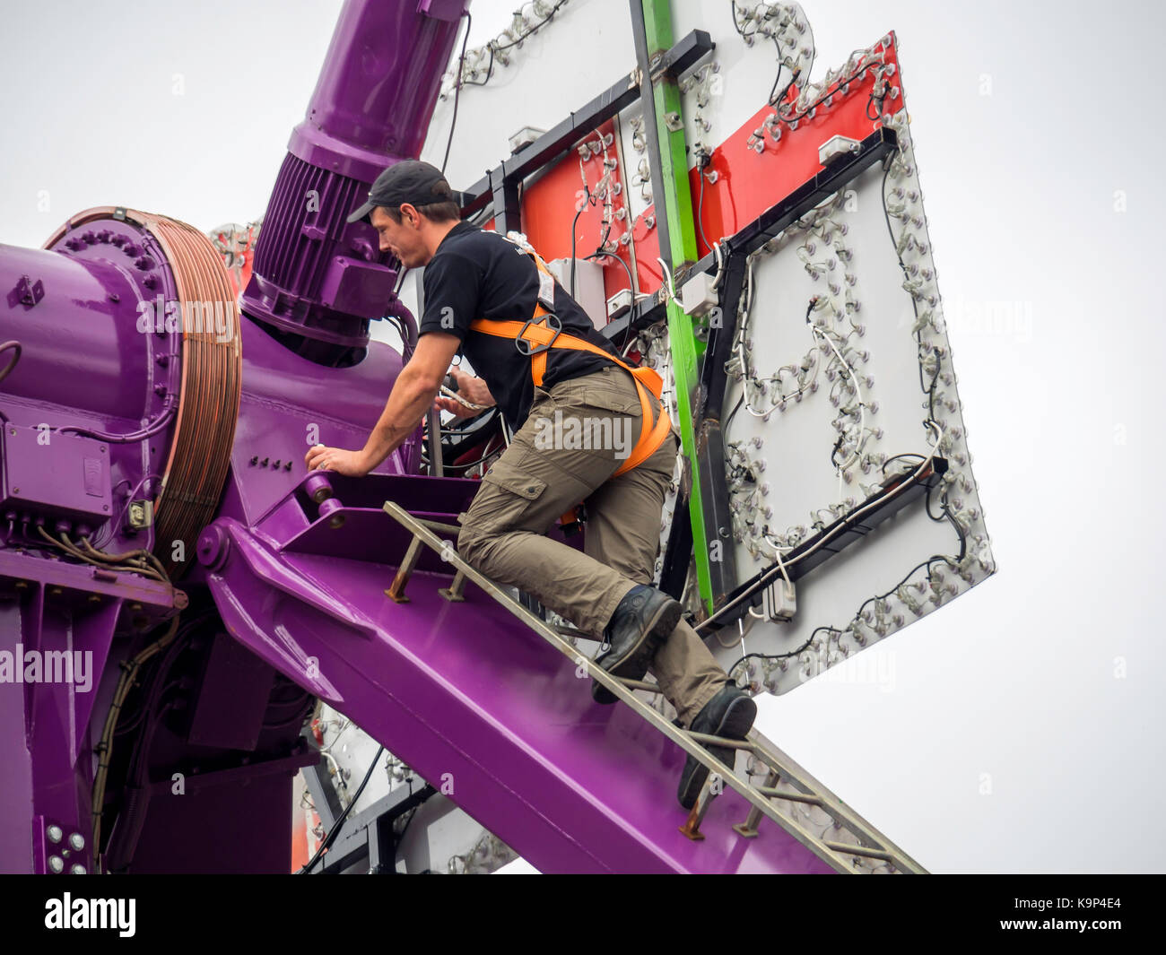 Workman wearing a safety harness for access to climb on a high ...