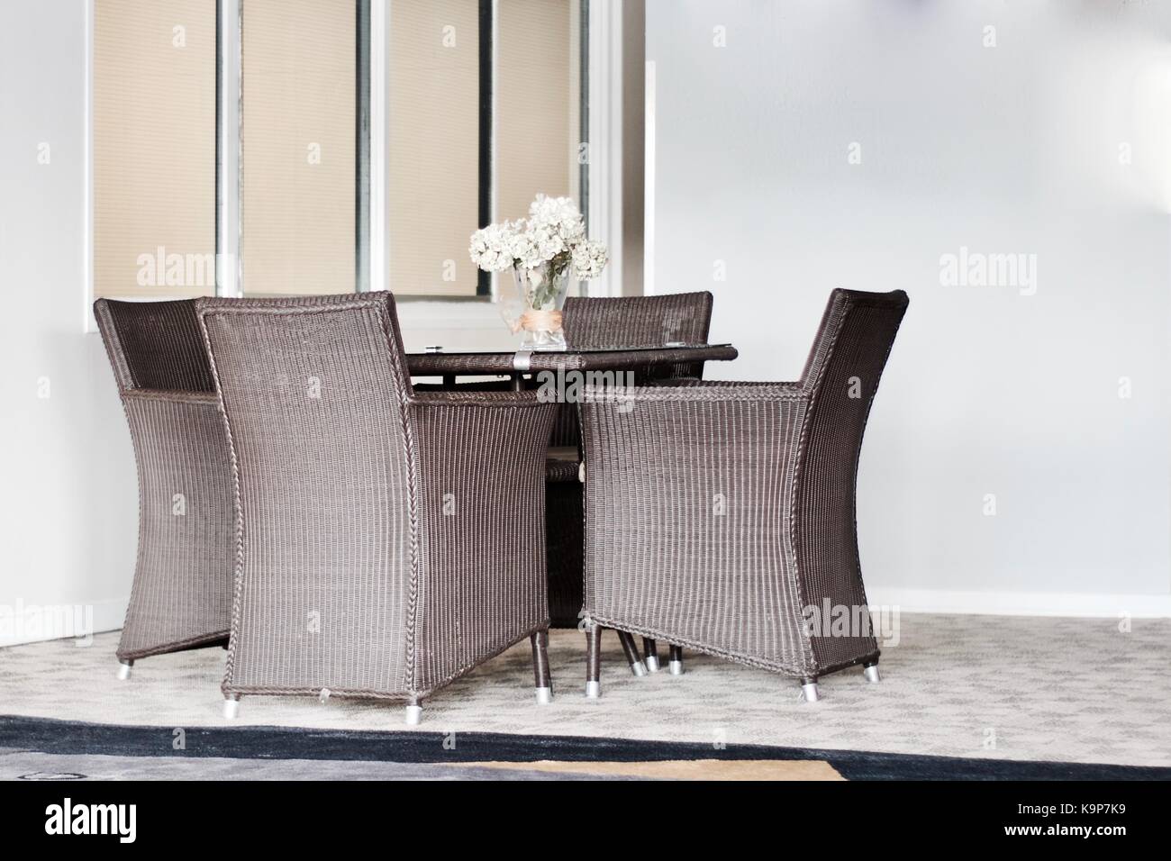 White flowers on the table near chairs in reception room on the gym ...