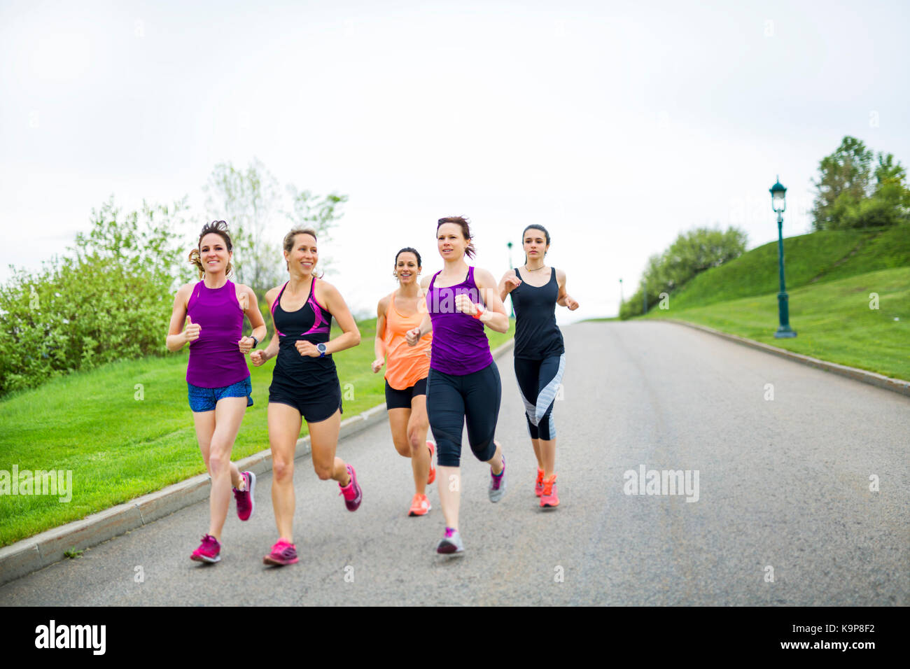 A group of people enjoying in the fitness having fun running outside ...