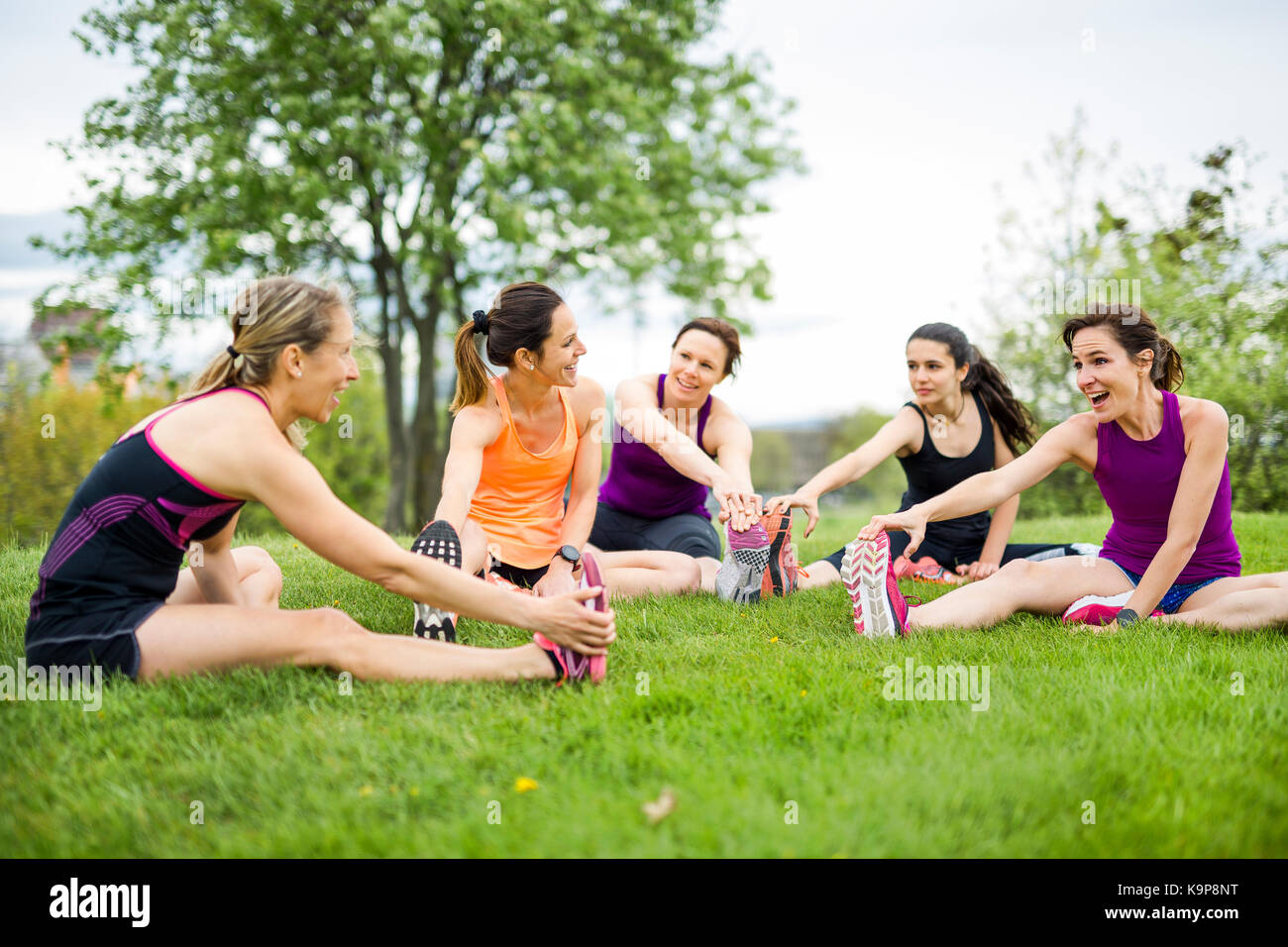 A group of people enjoying in the fitness having fun running outside ...