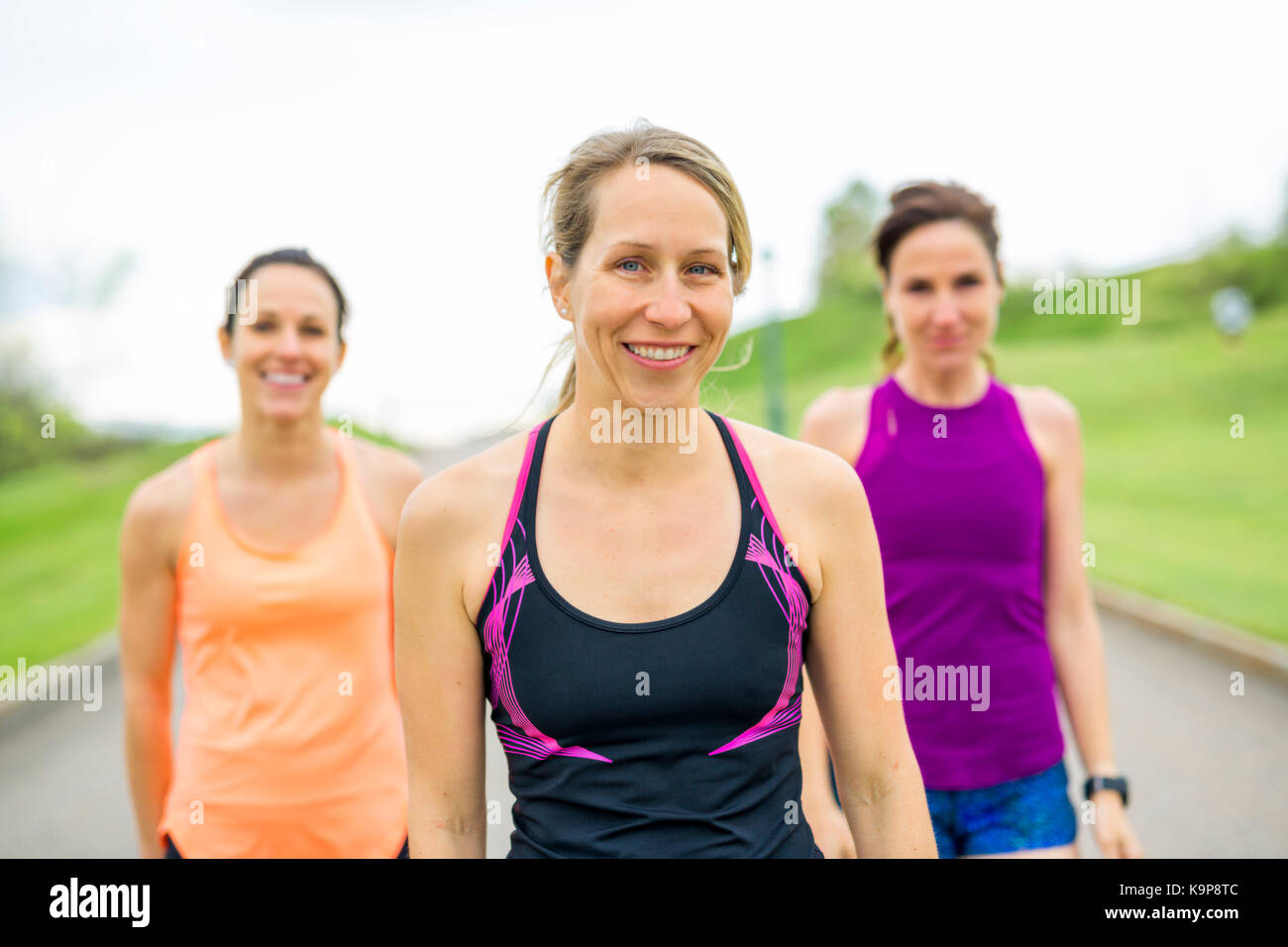 Three nice relaxed runners on a paved jogging daylight Stock Photo - Alamy