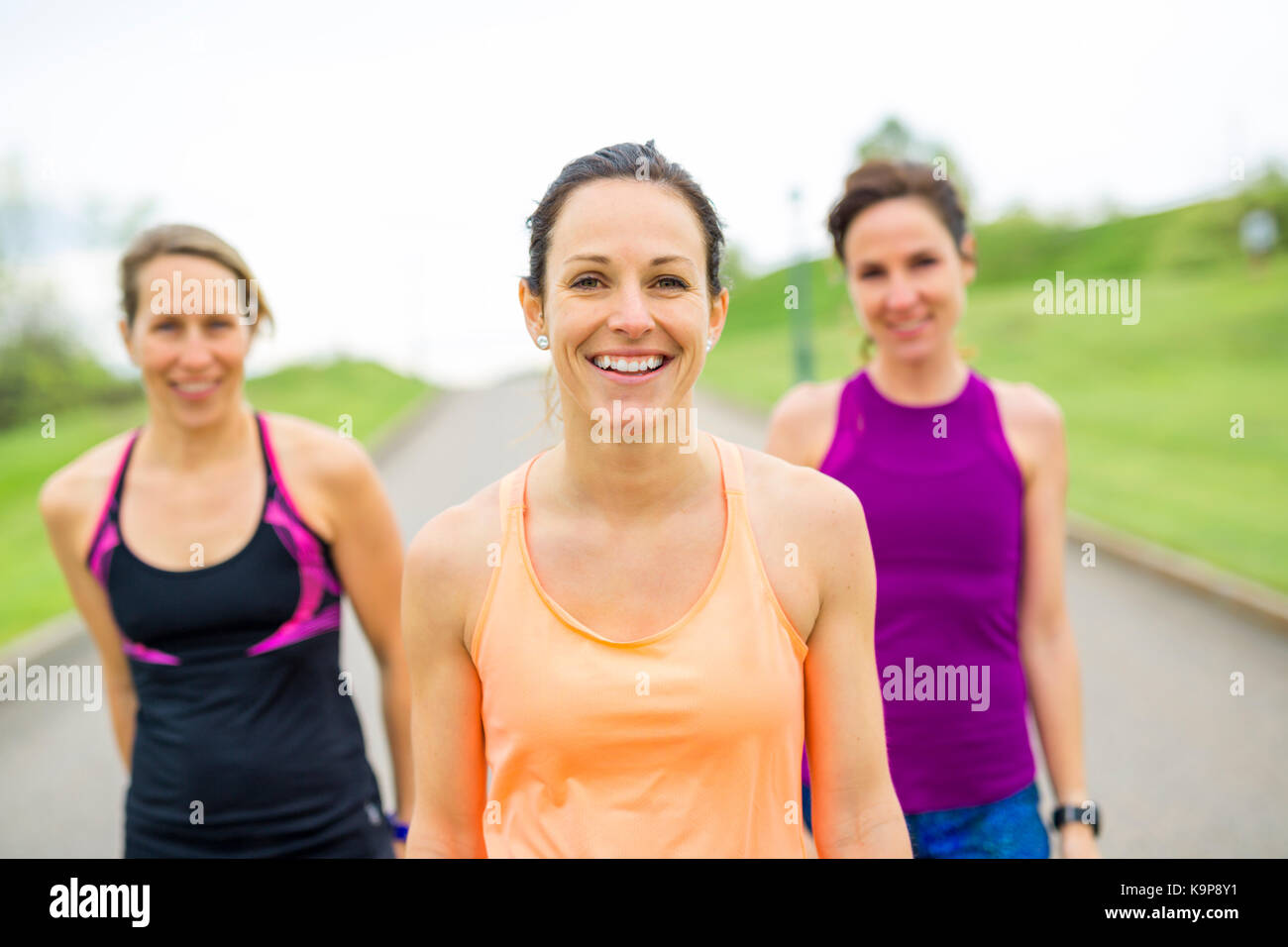 Three nice relaxed runners on a paved jogging daylight Stock Photo - Alamy