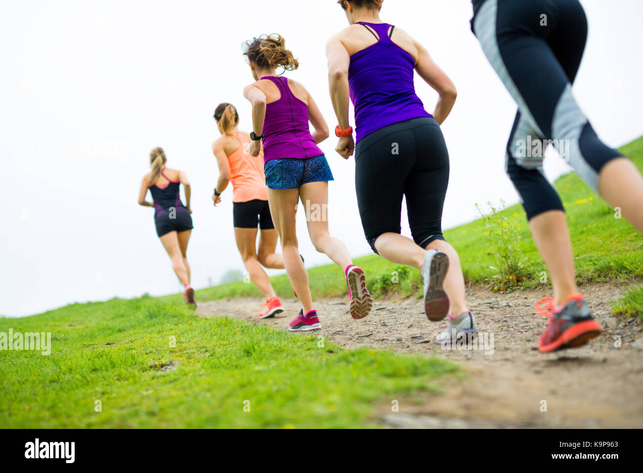 A group of people enjoying in the fitness having fun running outside ...