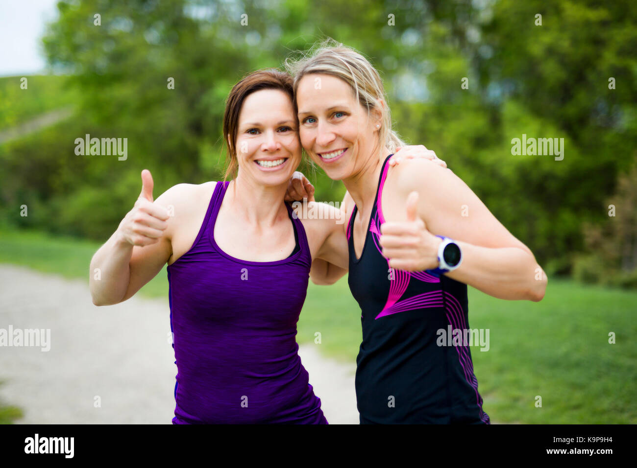 Two Beautiful Female runner outside having fun Stock Photo - Alamy
