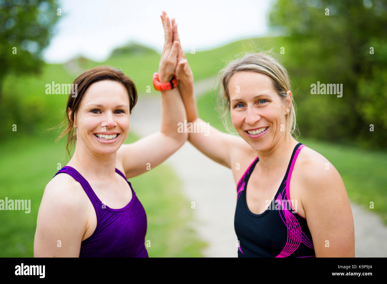 Two Beautiful Female runner outside having fun Stock Photo - Alamy