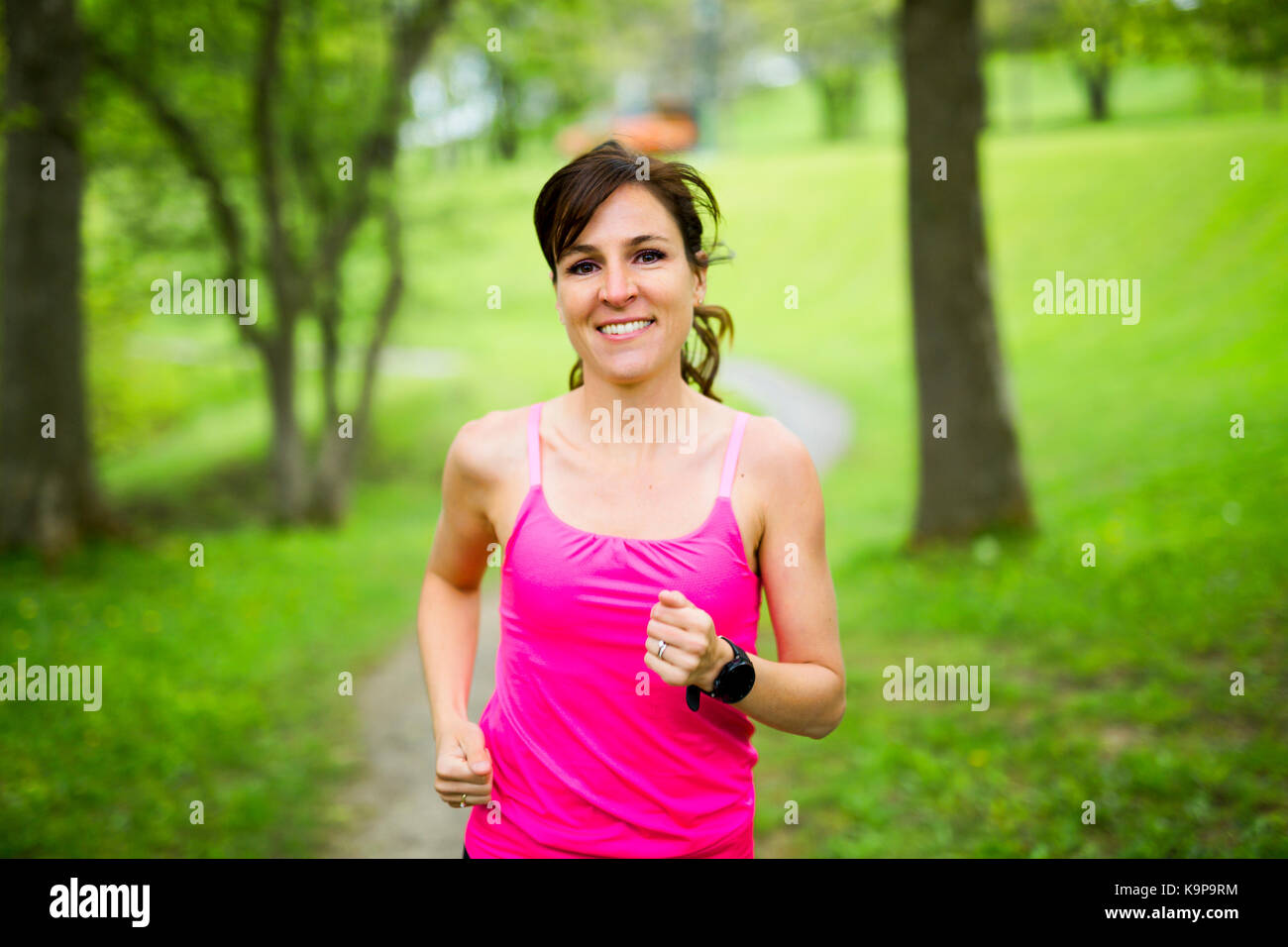 A nice portrait of a woman jogging outdoors Stock Photo - Alamy