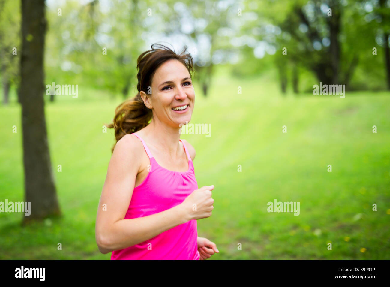 A nice portrait of a woman jogging outdoors Stock Photo - Alamy