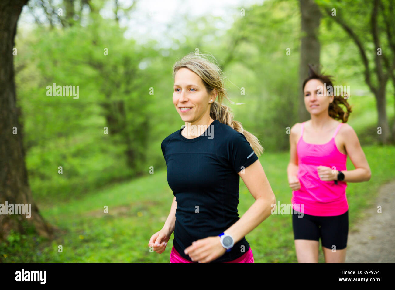 Two Beautiful Female runner outside having fun Stock Photo - Alamy