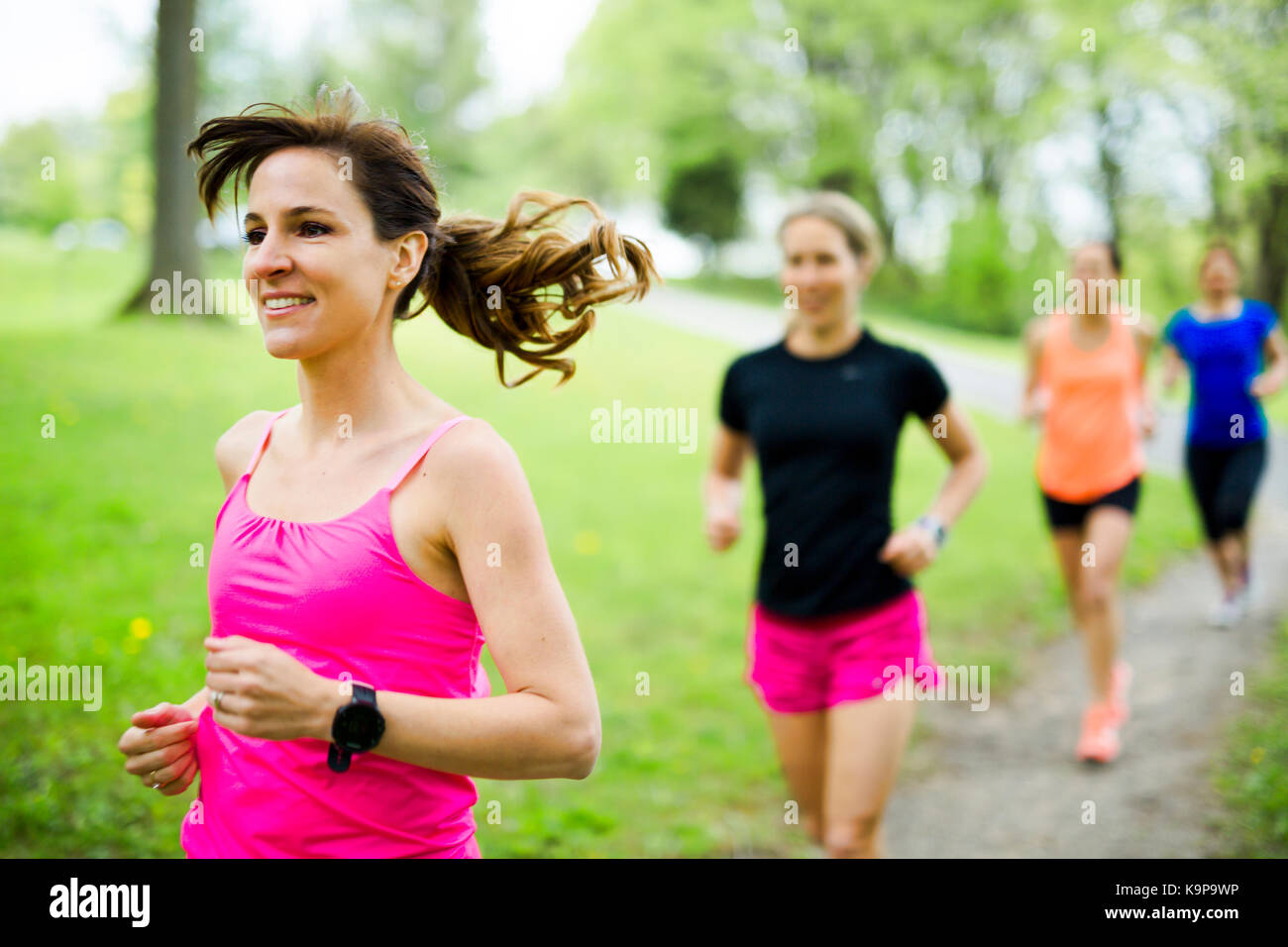 A group of people enjoying in the fitness having fun running outside ...