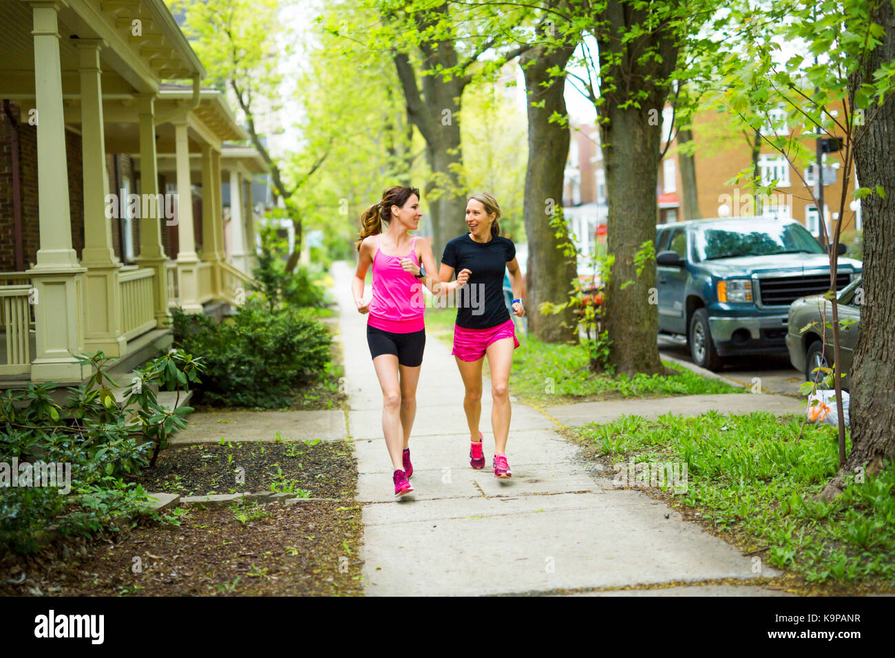 Two Beautiful Female runner outside having fun Stock Photo - Alamy