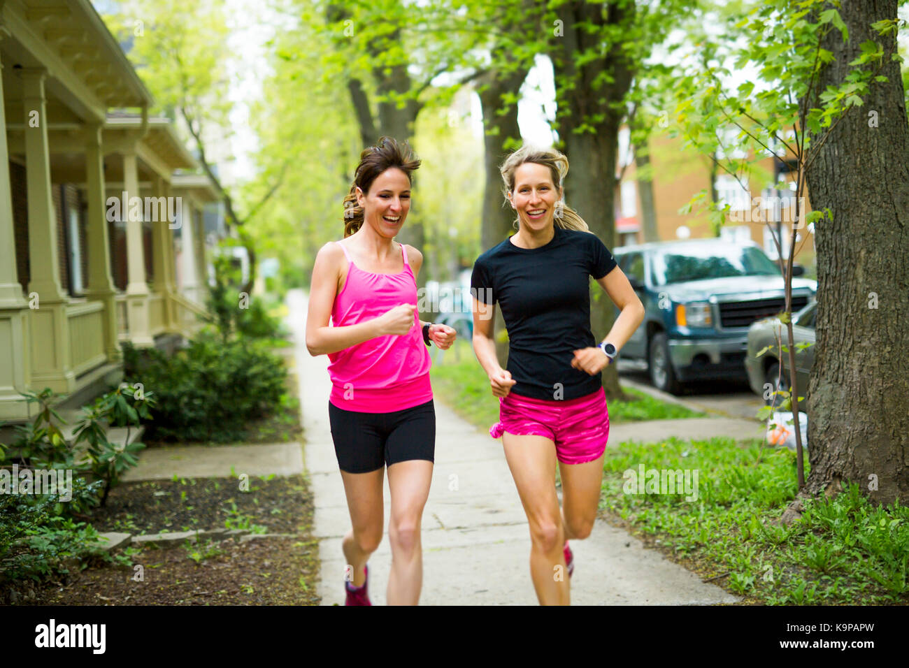 Two Beautiful Female runner outside having fun Stock Photo - Alamy