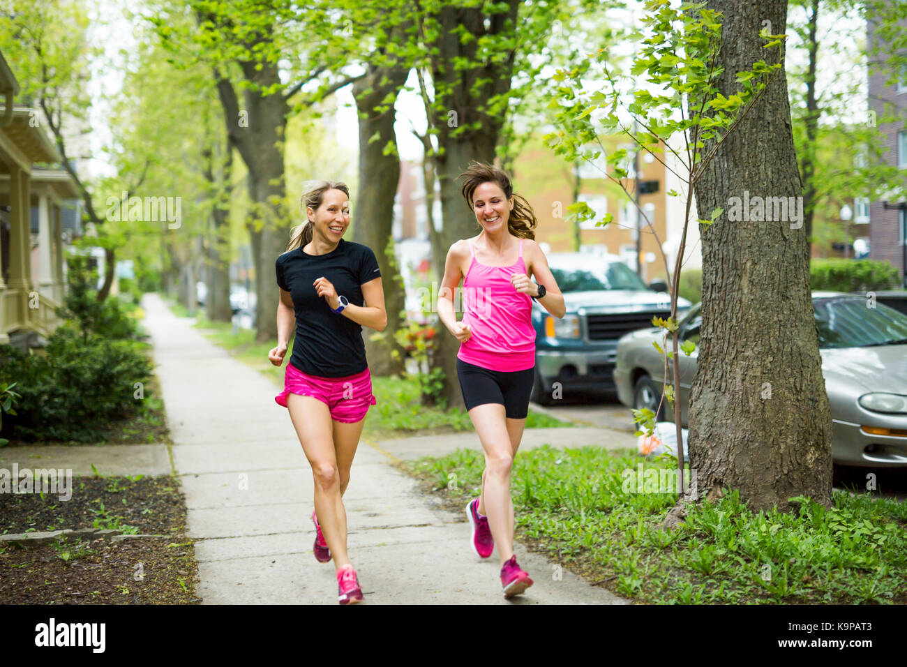 Two Beautiful Female runner outside having fun Stock Photo - Alamy