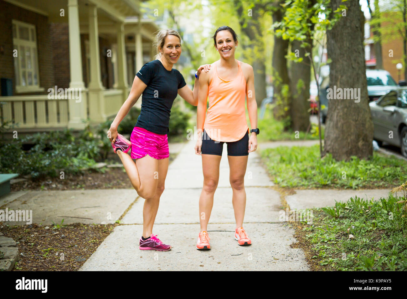 Two Beautiful Female runner outside having fun Stock Photo - Alamy