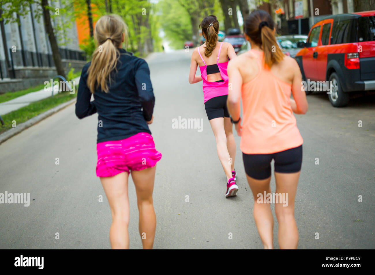 A group of people enjoying in the fitness having fun running outside ...