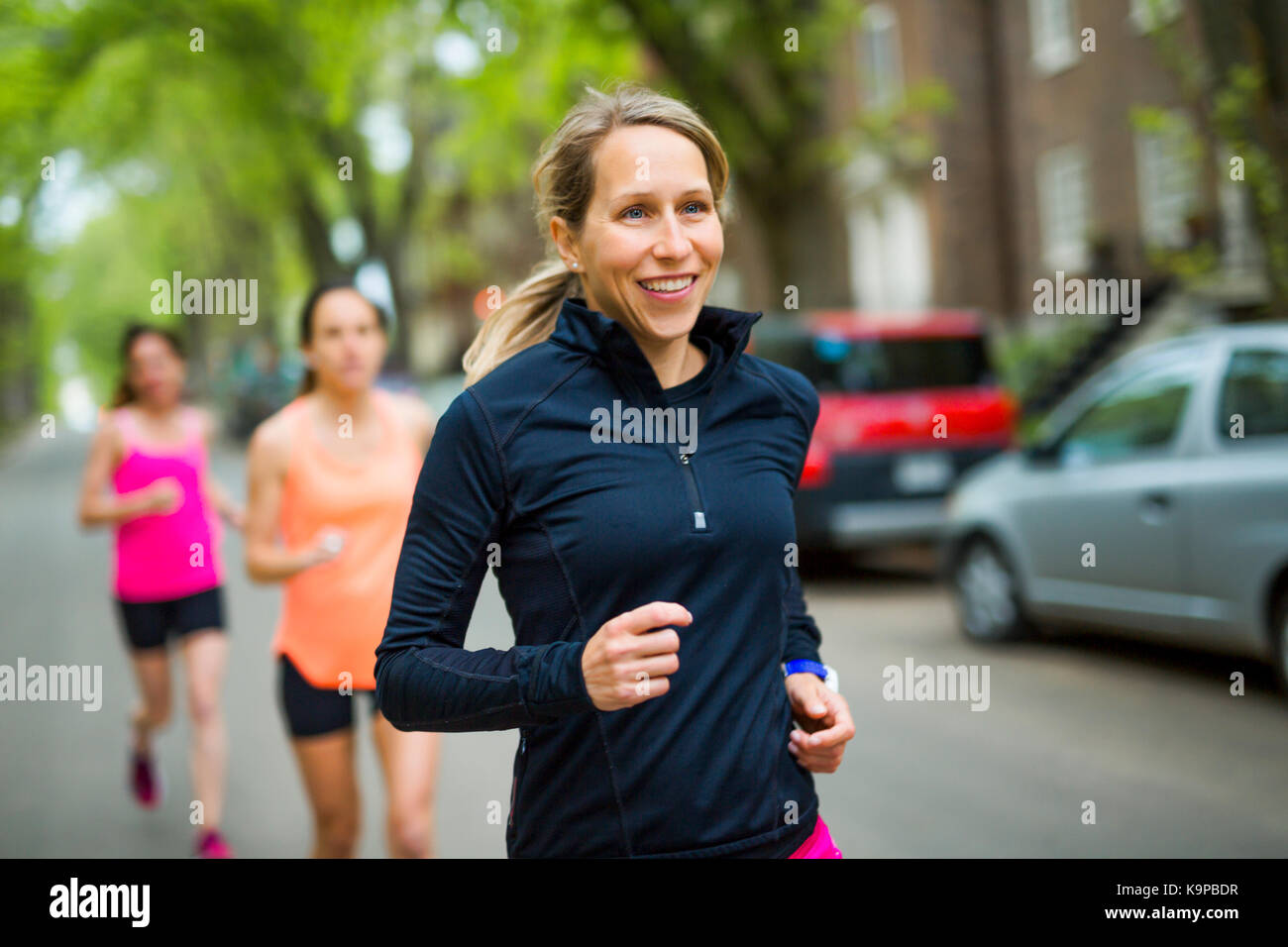 A group of people enjoying in the fitness having fun running outside ...