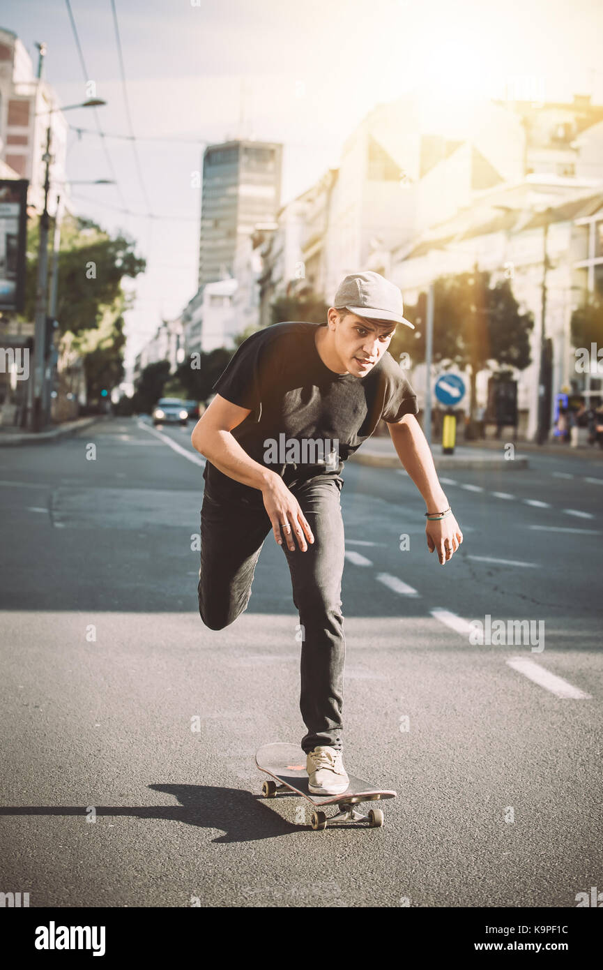 Professional skater riding skate on the main streets through cars and ...