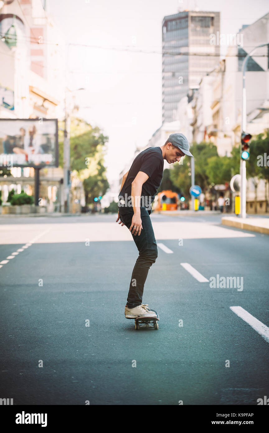 Professional skater riding skate on the main streets through cars and ...
