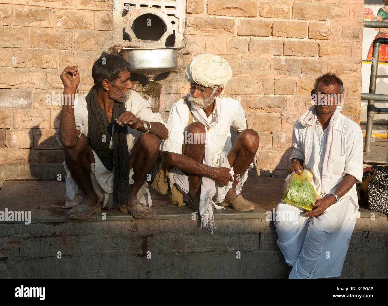 men sitting on a stoop, Rajasthan Stock Photo - Alamy