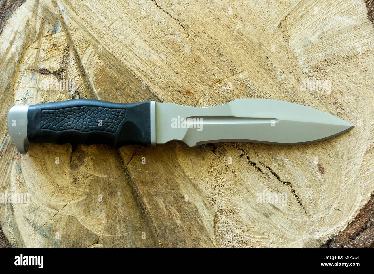 Military army knife on an oak stump. Dagger Stock Photo - Alamy