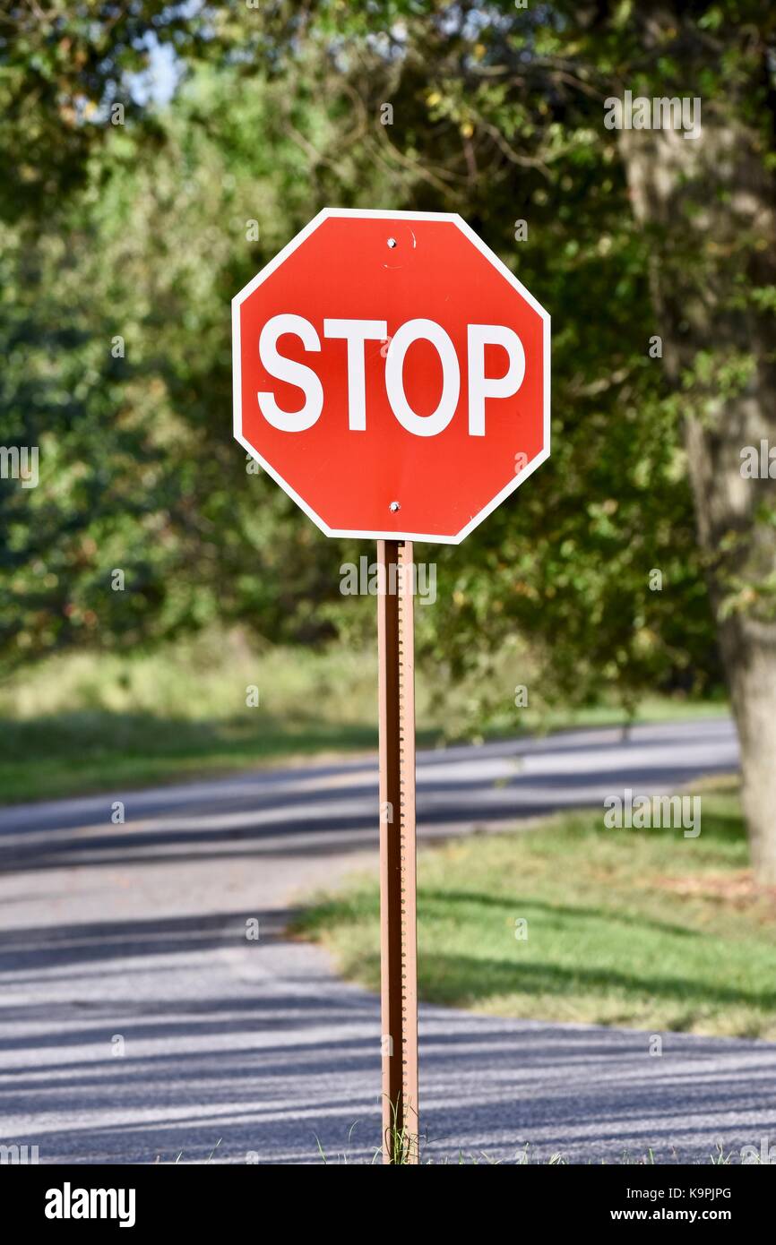 Stop sign on rural road Stock Photo - Alamy