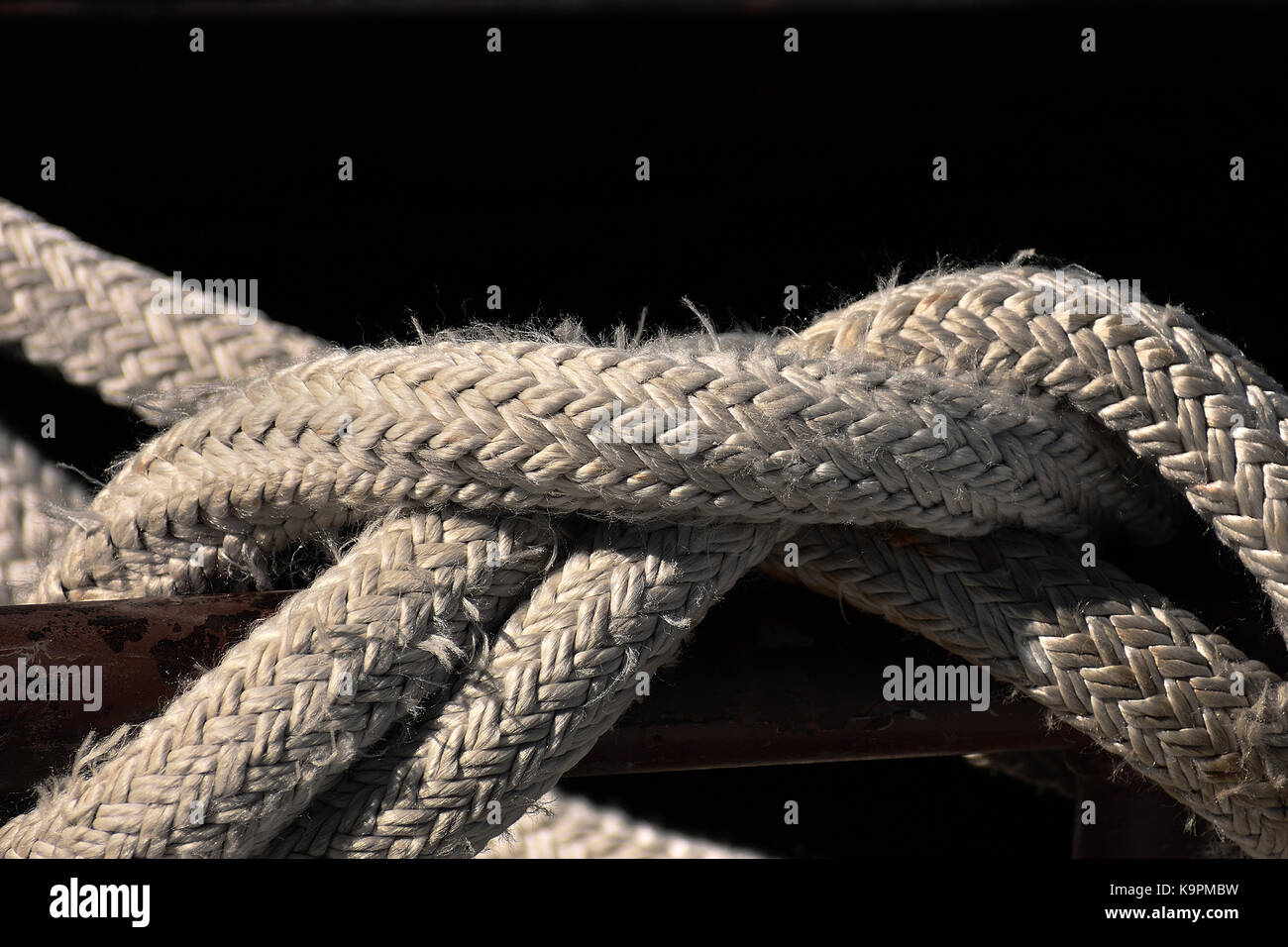 Rope knotted to a bollard at a wooden pier or wharf Stock Photo - Alamy