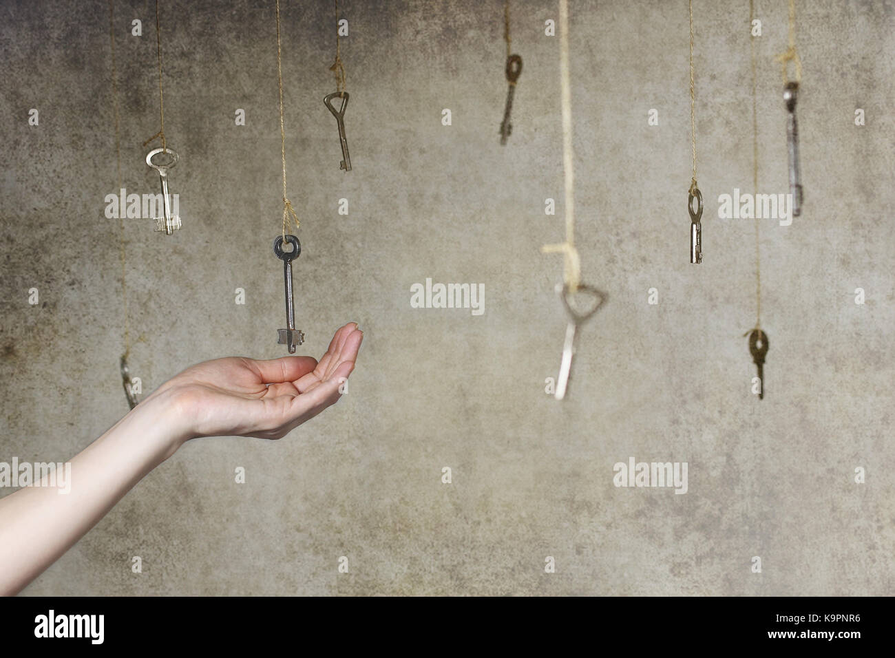 hand stretching for one of the many old vintage keys Stock Photo - Alamy