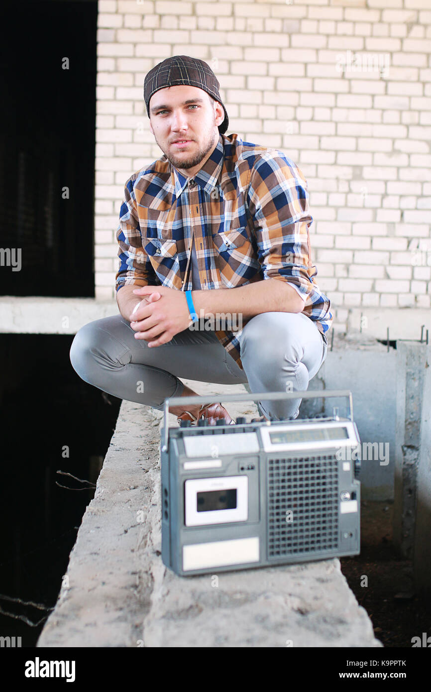 A man dressed in hip hop style poses Stock Photo - Alamy