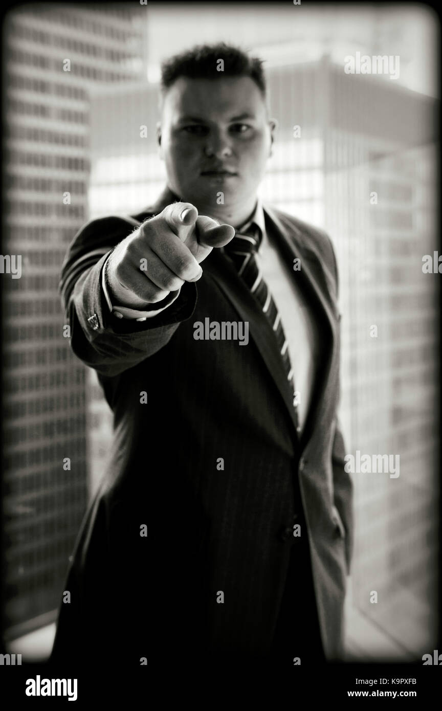 Young man in formal attire pointing finger Stock Photo - Alamy