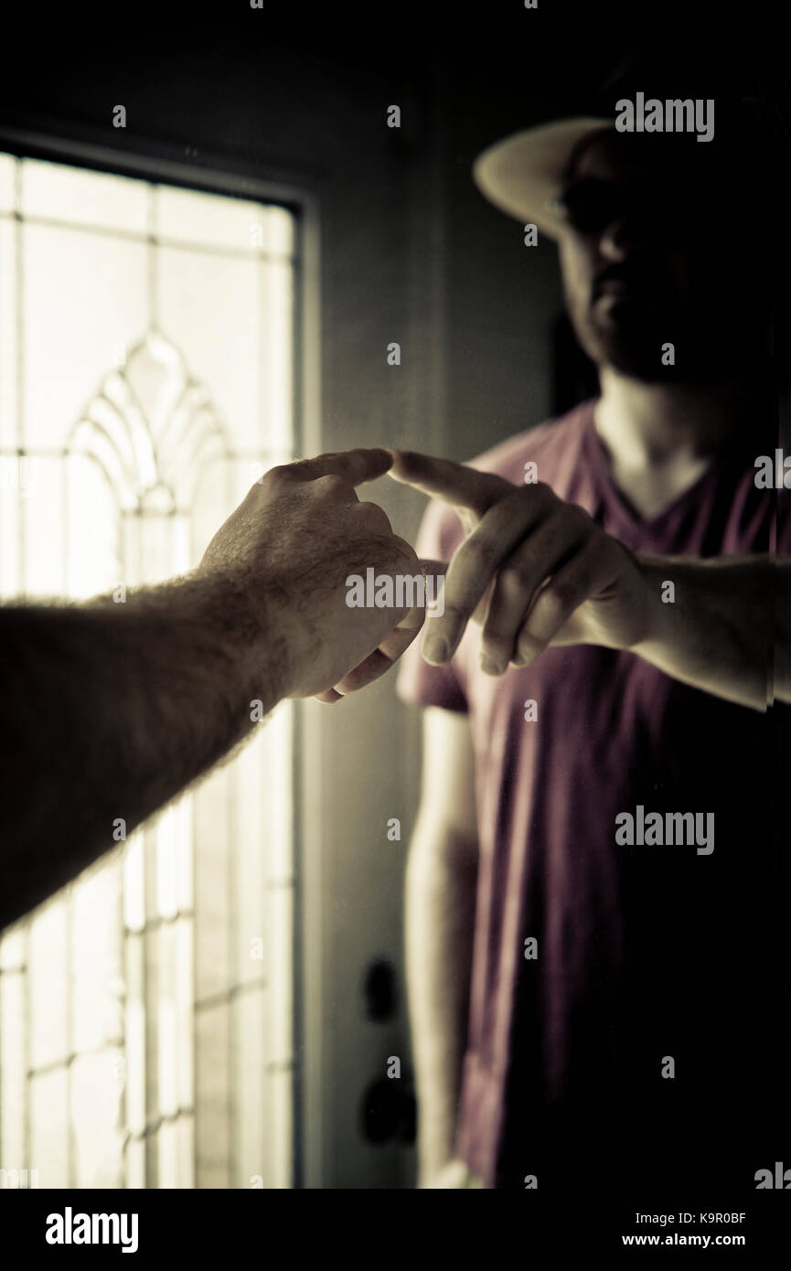 Man pointing finger at his reflection in the mirror Stock Photo - Alamy