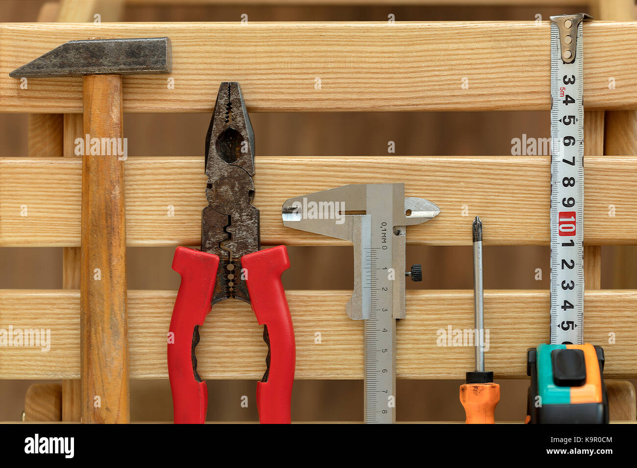 Old Construction tools are located vertically on pine horizontal wooden ...