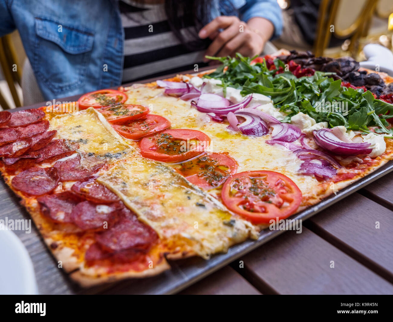 Thin crust pizza with multiple toppings (Pepperoni, Cheese, Tomato ...