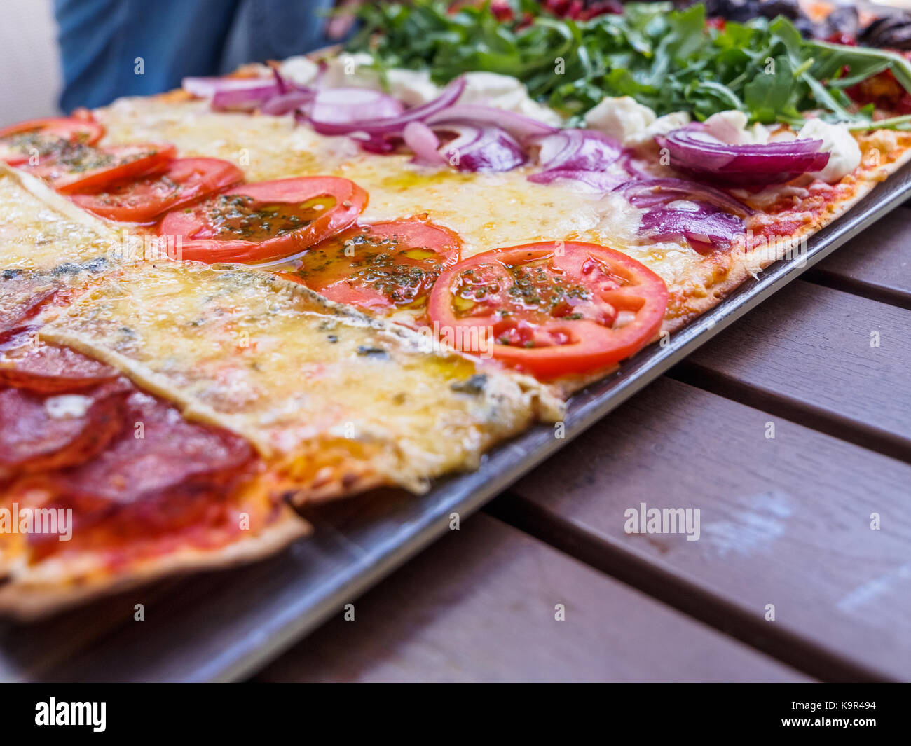 Thin crust pizza with multiple toppings (Pepperoni, Cheese, Tomato ...