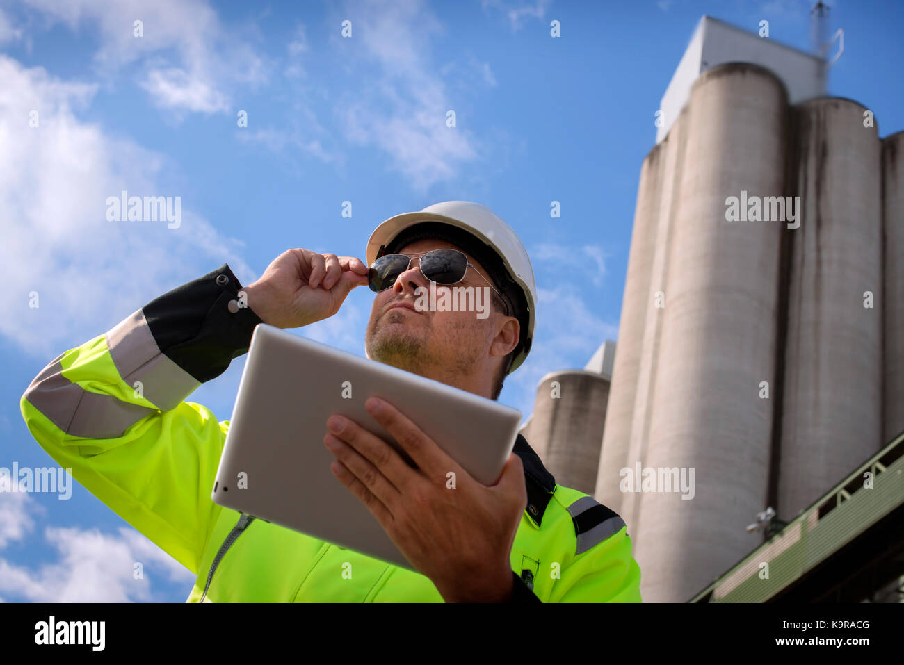 Construction engineer against blue sky Stock Photo - Alamy