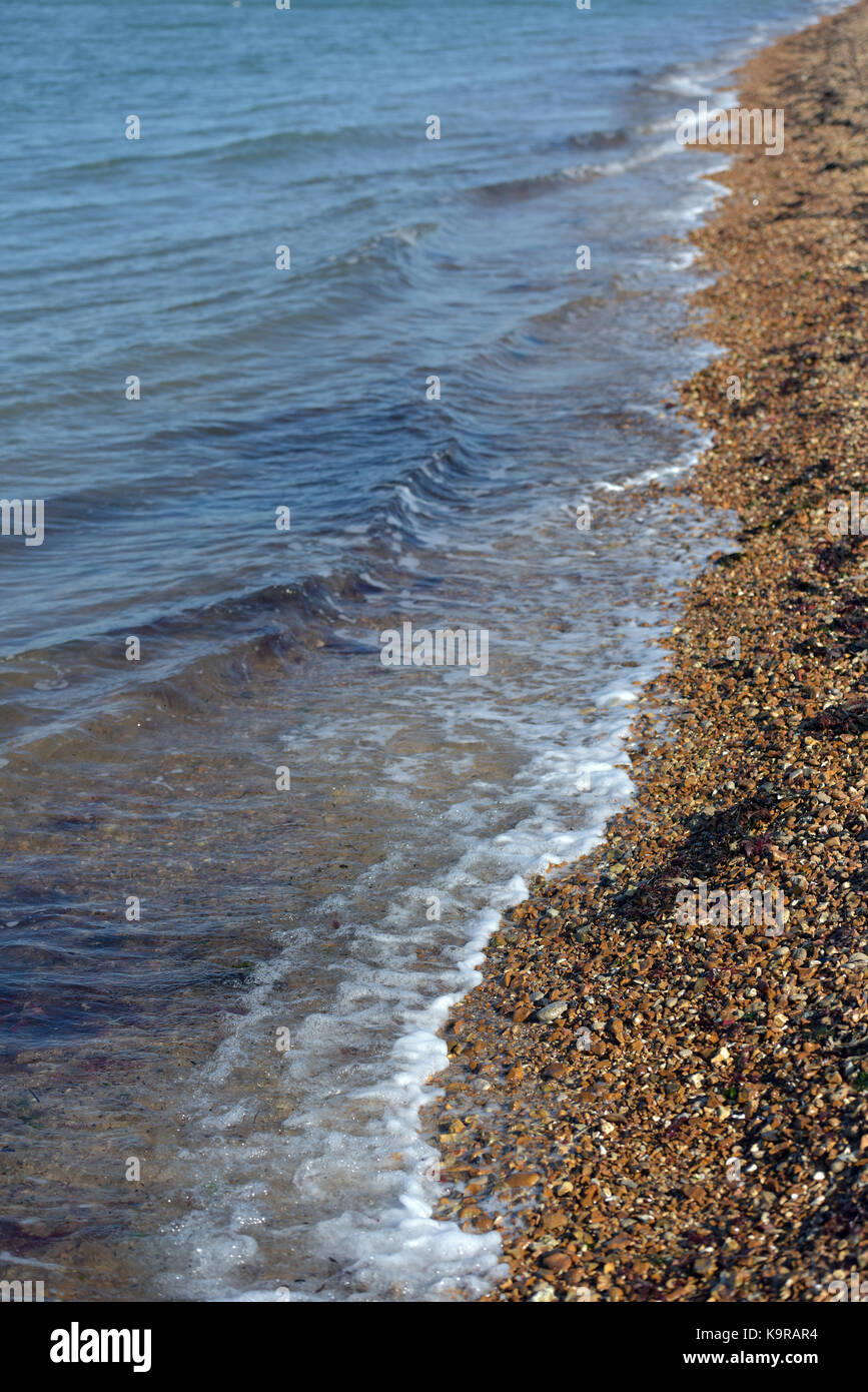 seashore and waves lapping onto a shingle beach Stock Photo - Alamy
