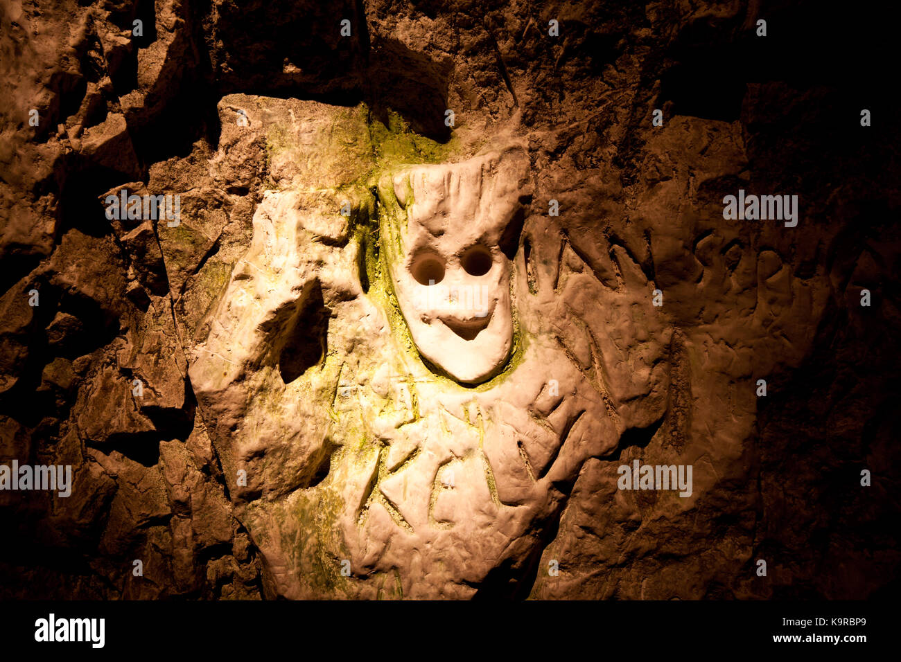 Chalk carving of face in hand-dug tunnel (placing fingers in eyes ...