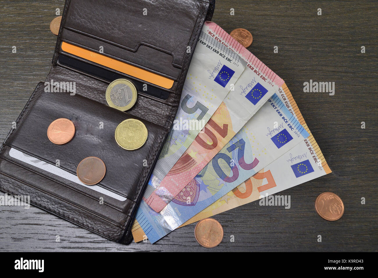 leather wallet with various euro banknotes and coins Stock Photo - Alamy