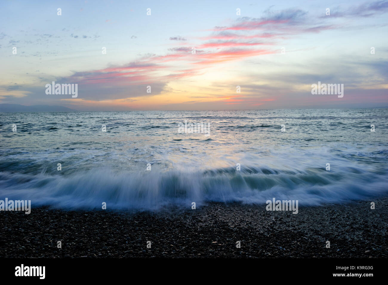 Ocean sunset is a serene scenic seascape on the beach with the bright ...